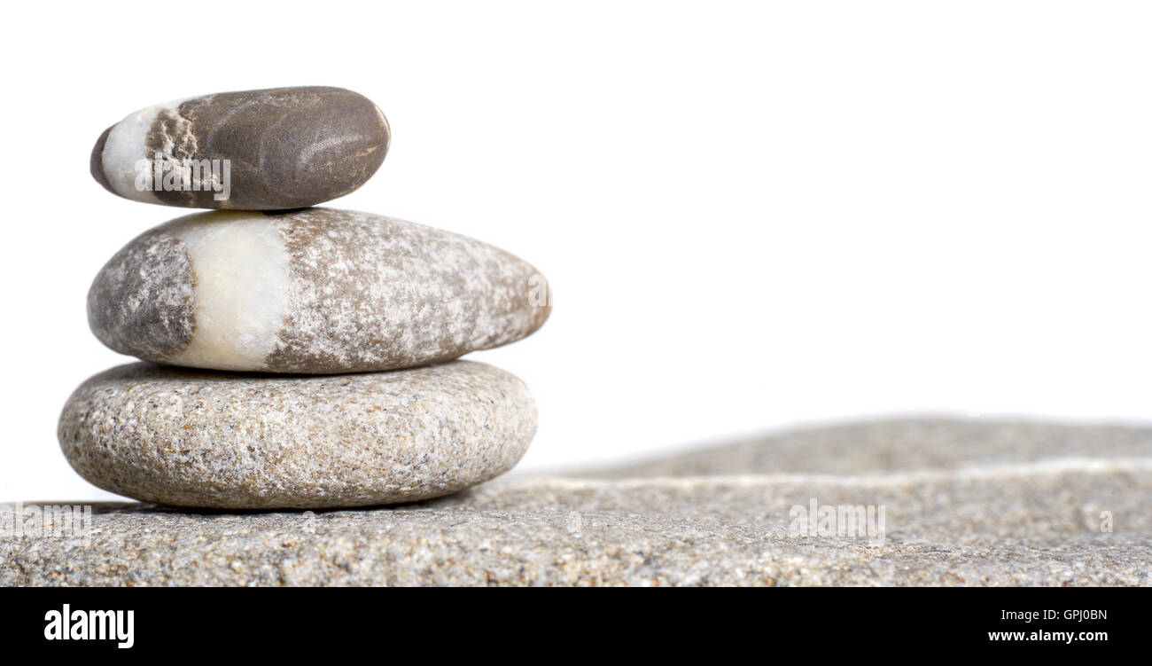 stacked rounded stone pebble arrangement in white back Stock Photo - Alamy