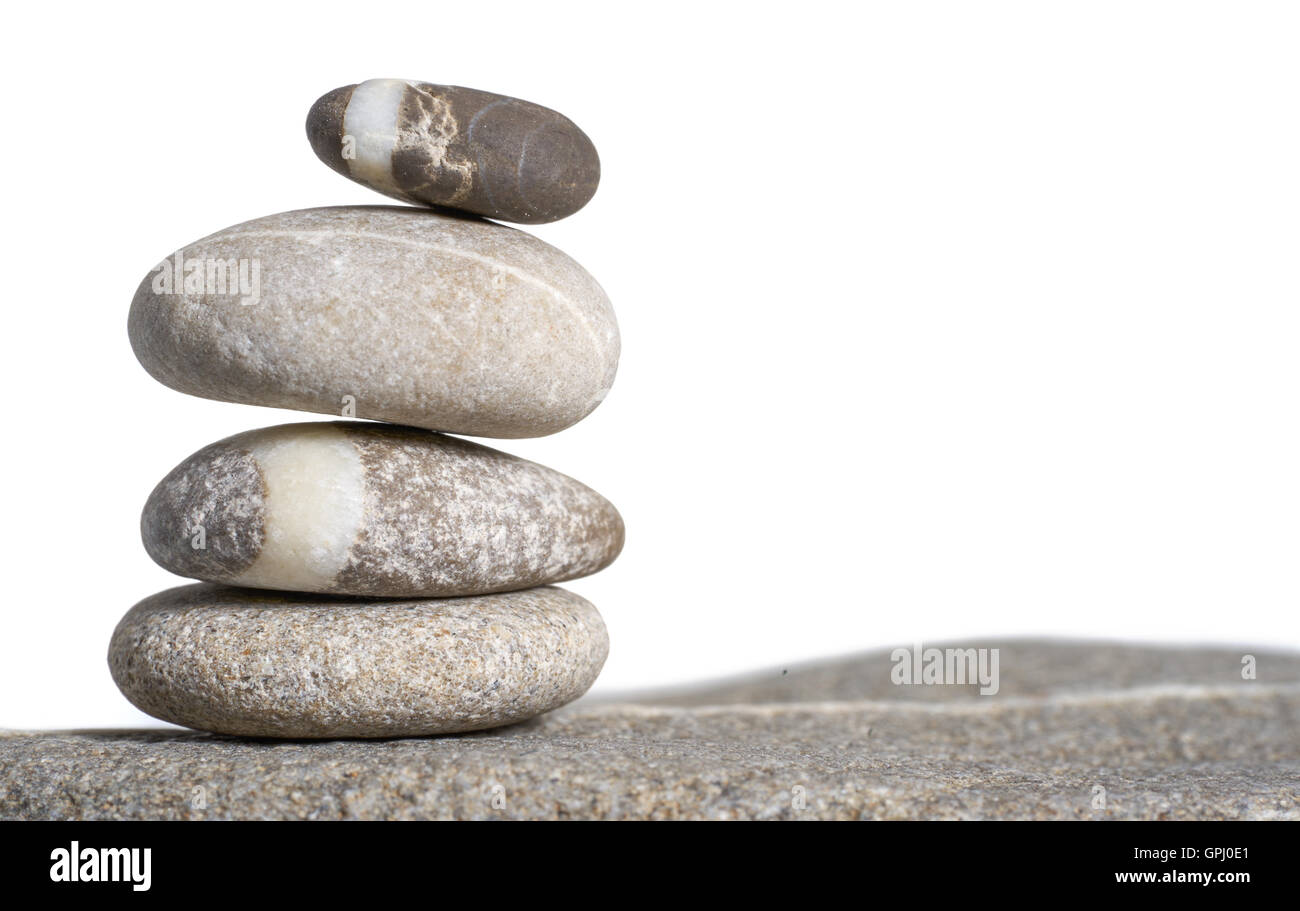 stacked rounded stone pebble arrangement in white back Stock Photo - Alamy