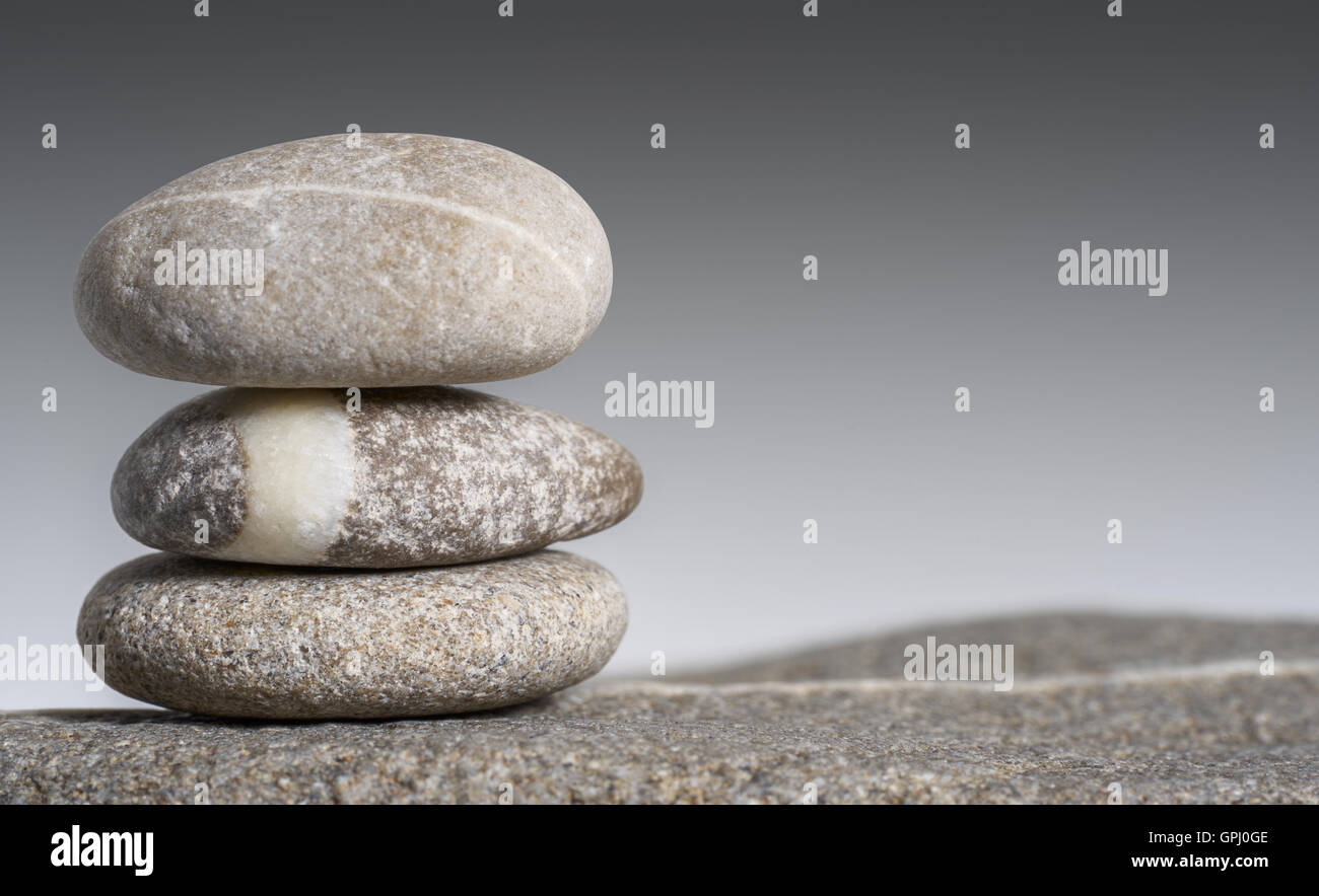 stacked rounded stone pebble arrangement in gradient grey back Stock ...