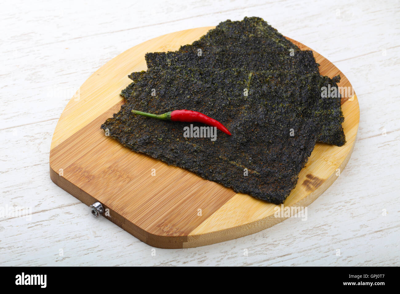 Spicy Nori seaweed sheets with pepper on wood Stock Photo - Alamy