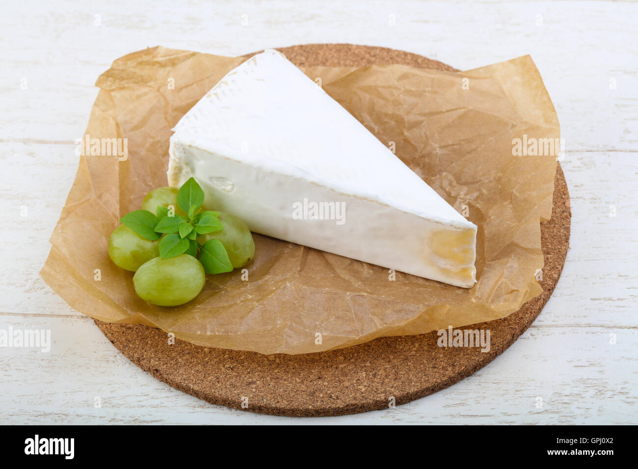 Brie cheese with grape on wood background Stock Photo - Alamy