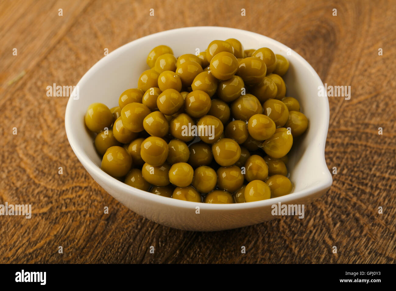 Pickled green pea on the wood background Stock Photo - Alamy