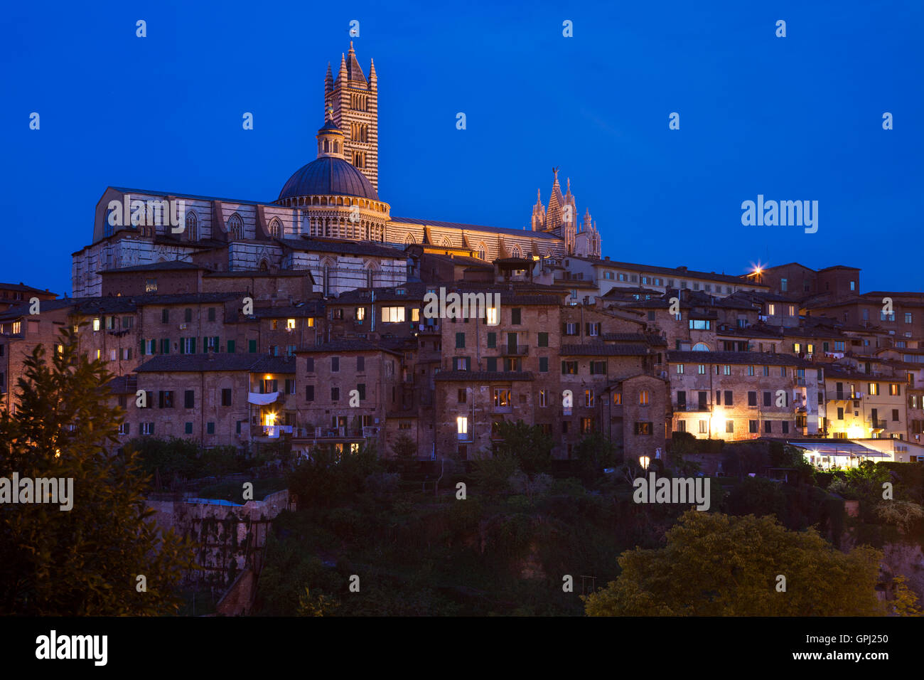 View over Siena old town and Duomo cathedral in the evening Stock Photo ...