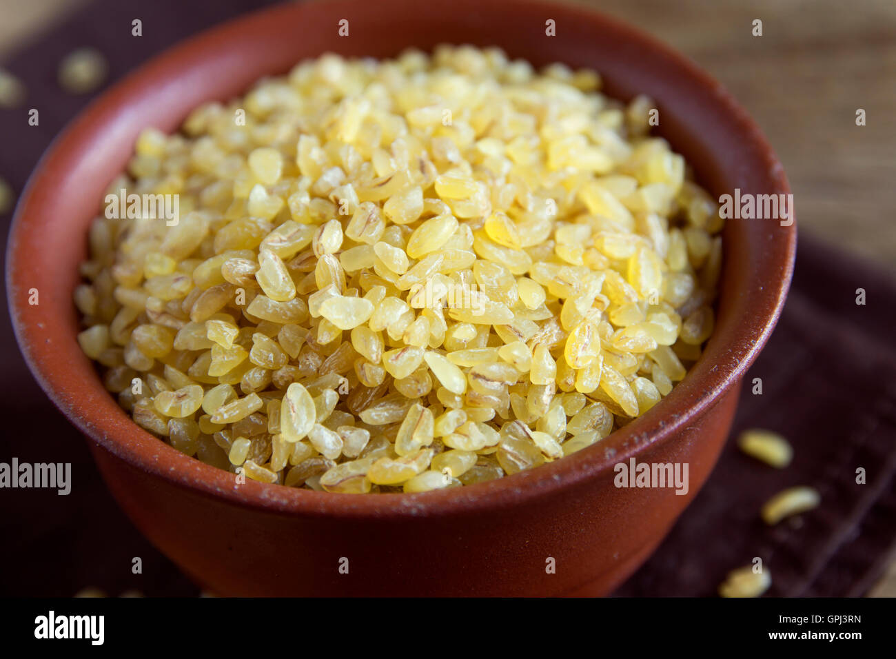 Organic bulgur raw wheat grain in ceramic bowl close up Stock Photo - Alamy