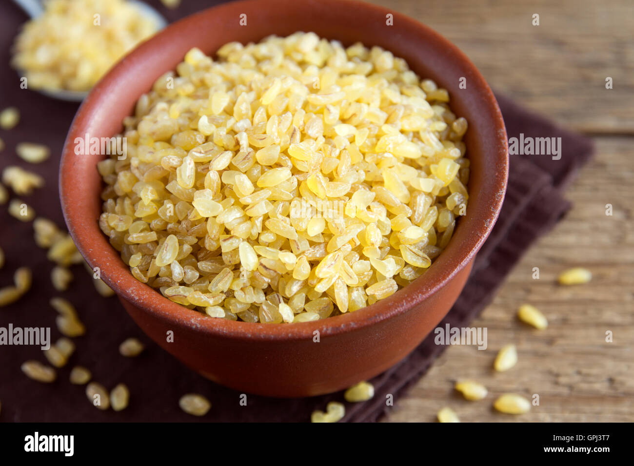 Organic bulgur raw wheat grain in ceramic bowl close up Stock Photo - Alamy