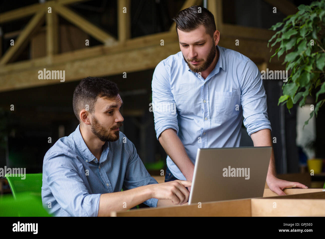 Businessman typing on laptop at office desk hi-res stock photography ...