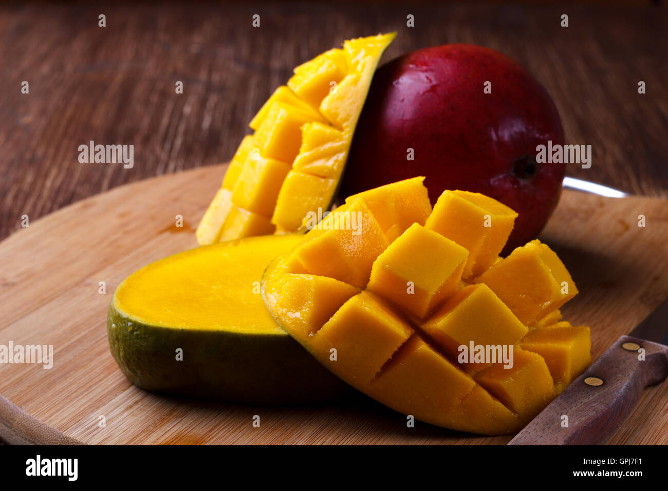 Fresh mango organic product on wooden background Stock Photo - Alamy
