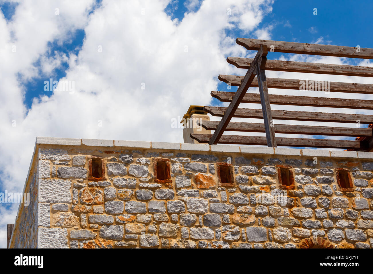 Traditional style Greek house detail with stone walls and small windows ...