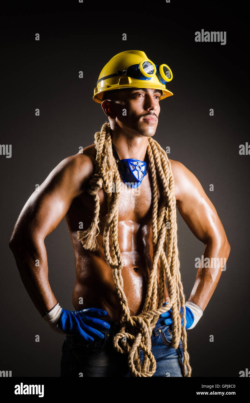 Construction worker in dark studio Stock Photo - Alamy