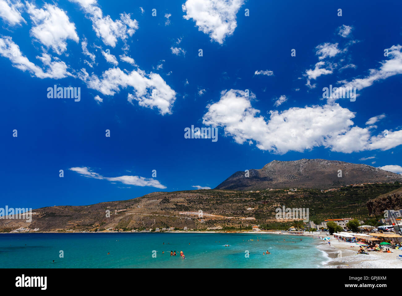 Sun bathers enjoying the beach and playing water games at Neo Itilo ...