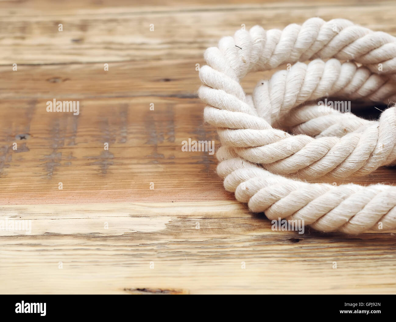 rope on weathered wood background with copy space Stock Photo - Alamy