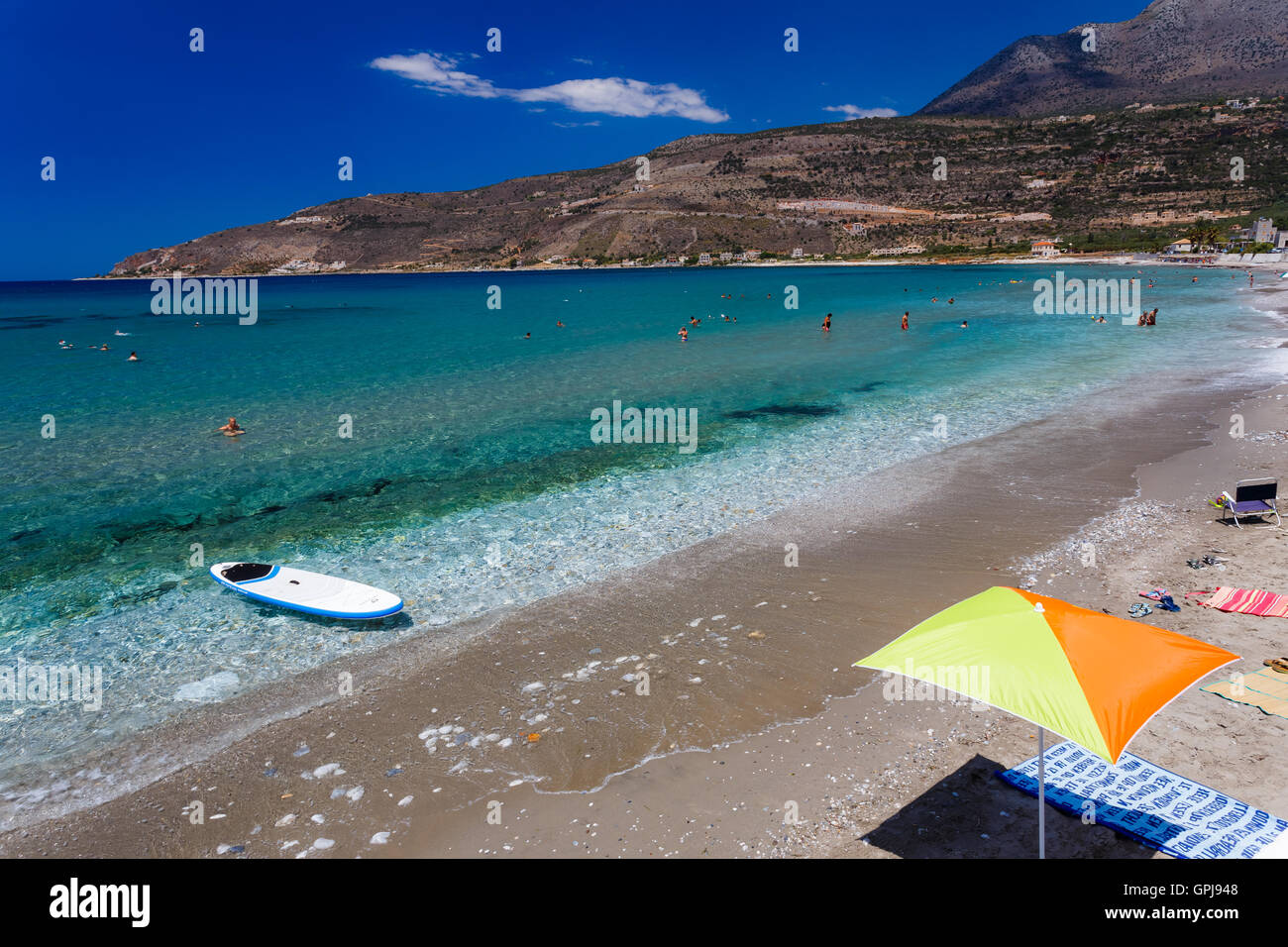 Sun bathers enjoying the beach and playing water games at Neo Itilo ...