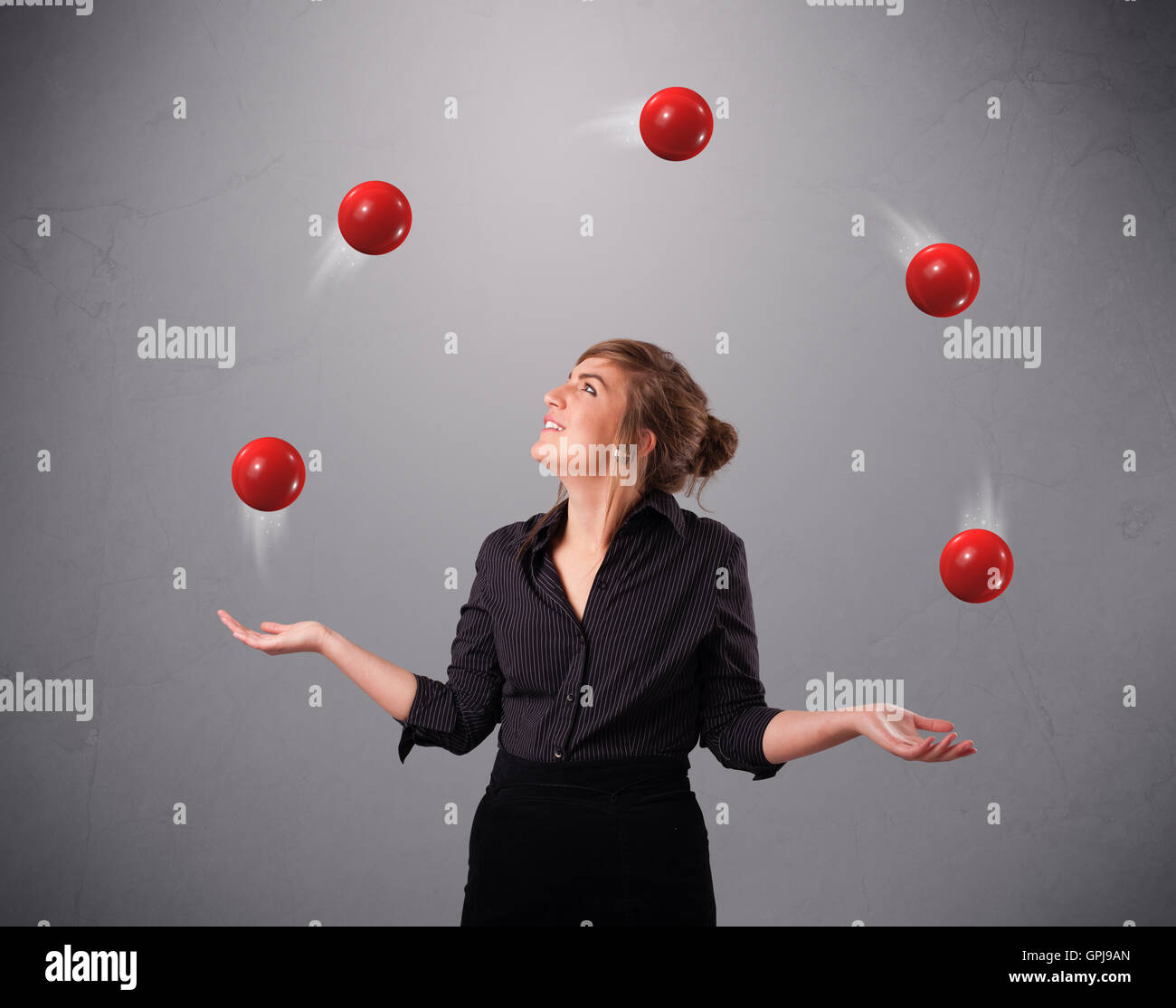 young girl standing and juggling with red balls Stock Photo - Alamy