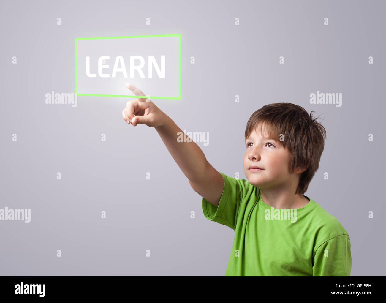 Kid touching LEARN button Stock Photo - Alamy