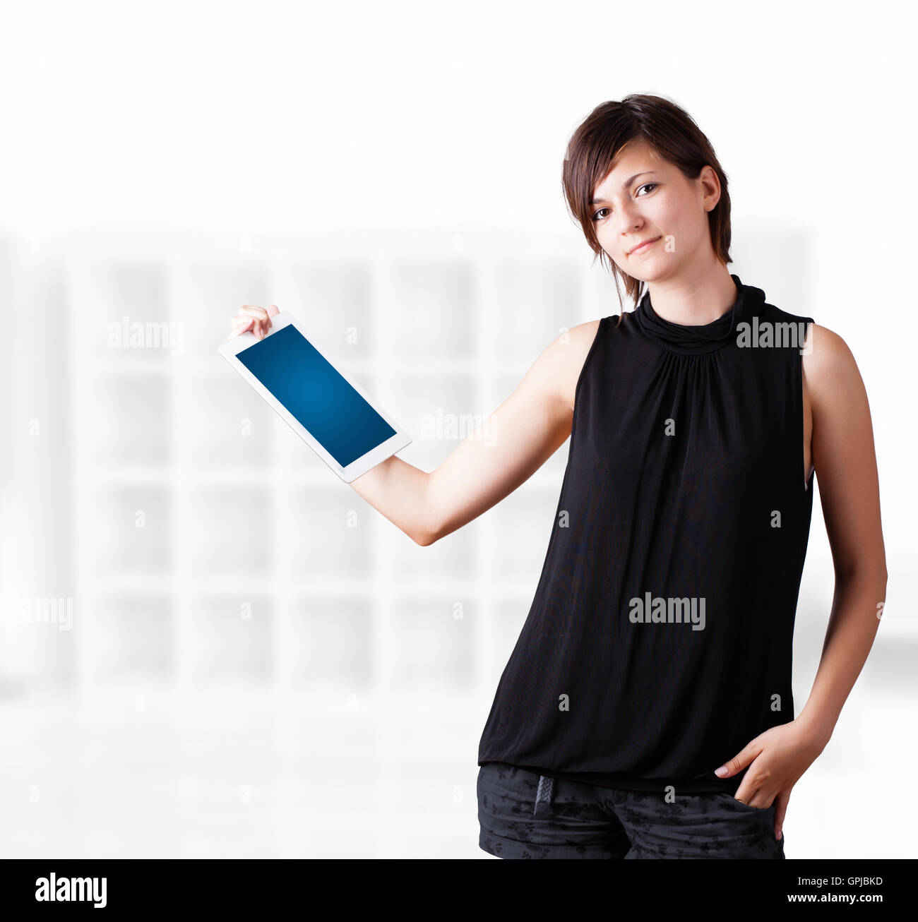 Young woman looking at modern tablet Stock Photo - Alamy