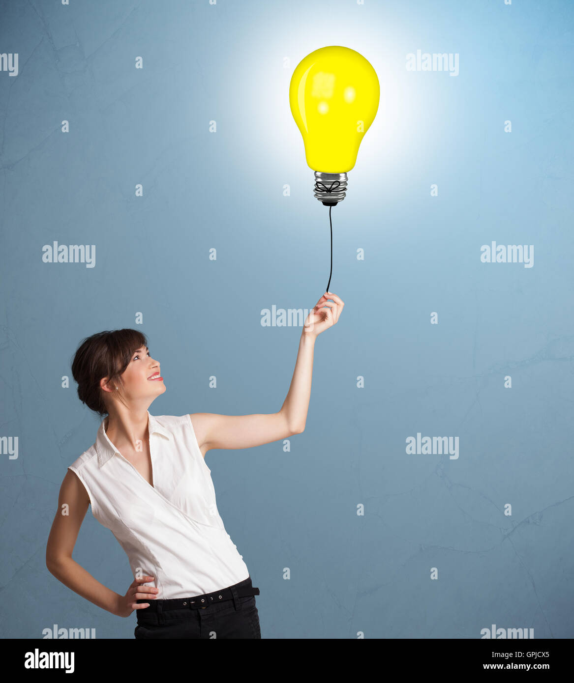 Pretty lady holding a light bulb balloon Stock Photo - Alamy