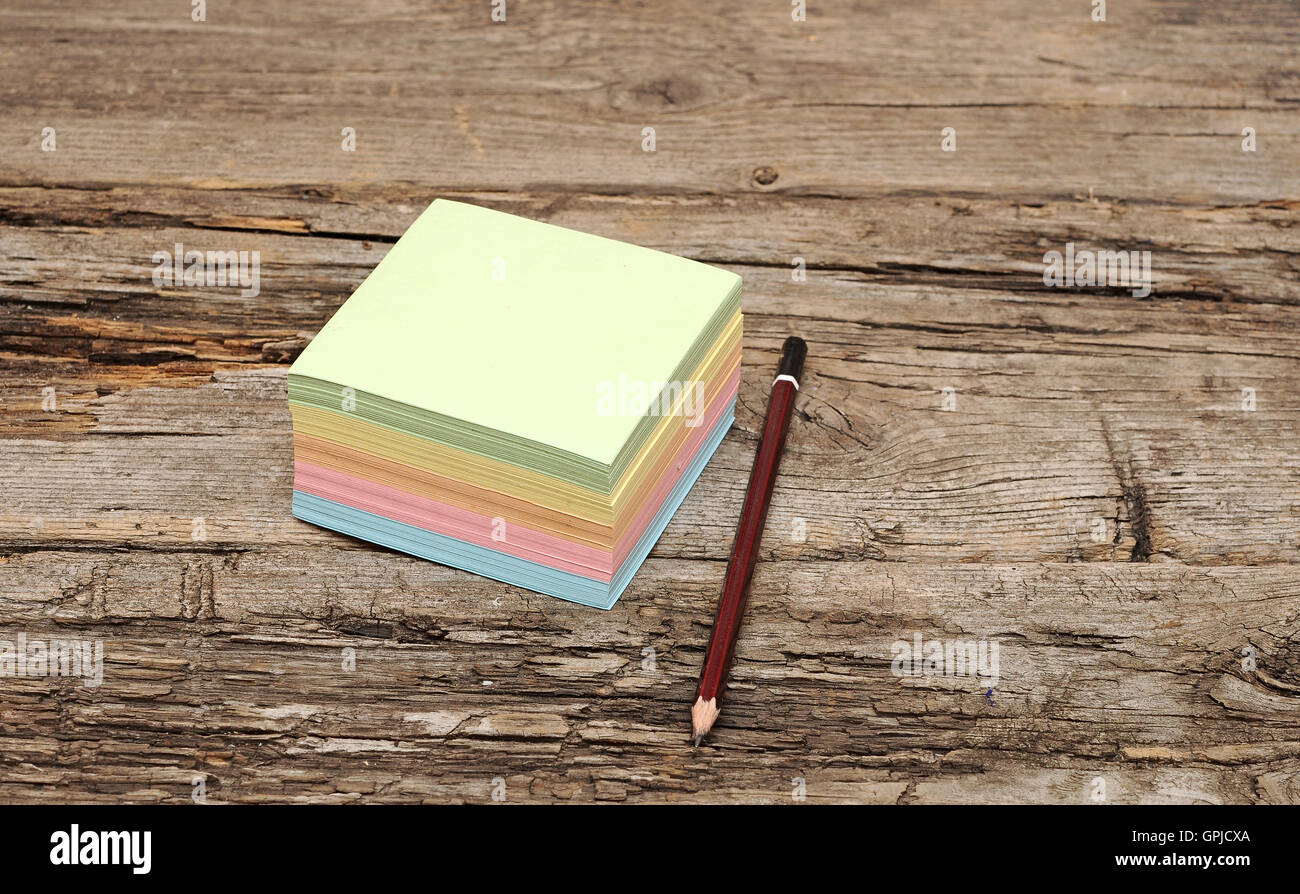 paper note and pencil on wooden background Stock Photo - Alamy
