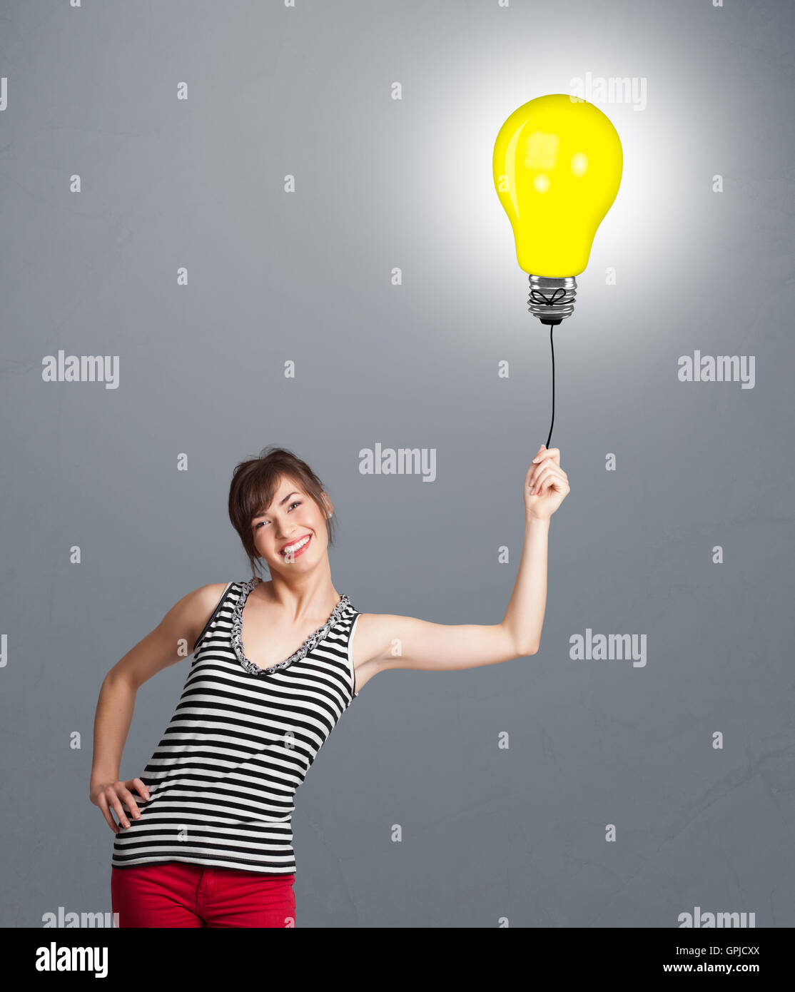Pretty lady holding a light bulb balloon Stock Photo - Alamy