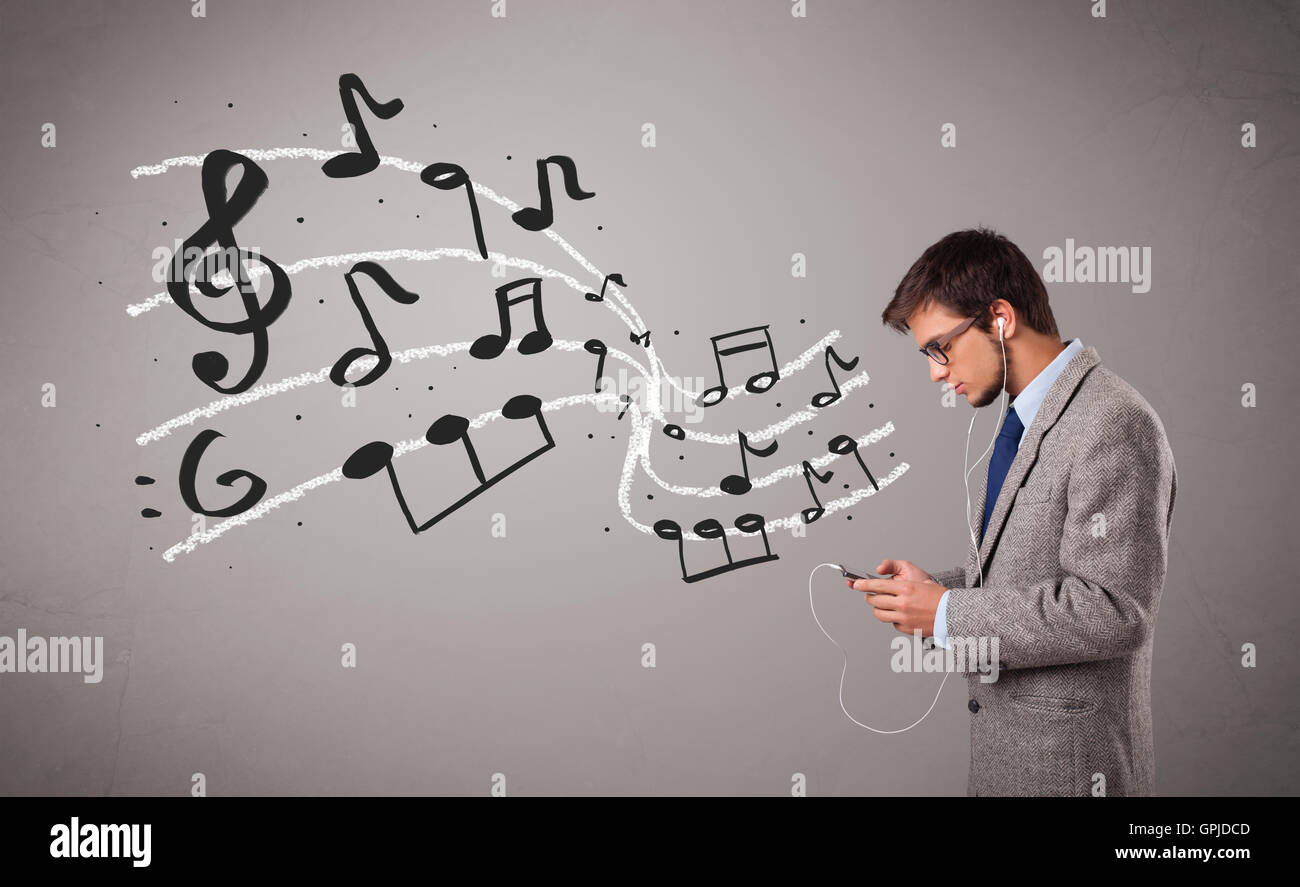 handsome boy singing and listening to music with musical notes Stock ...