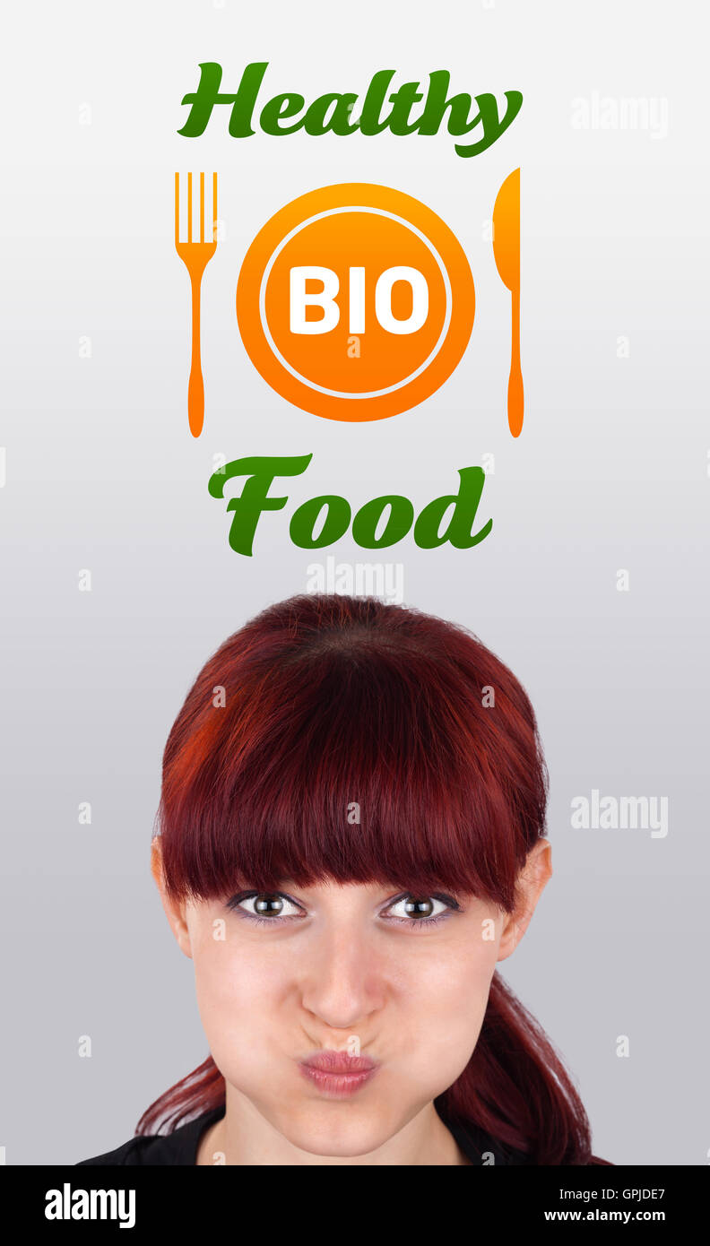 Young girl looking at healthy food sign Stock Photo - Alamy