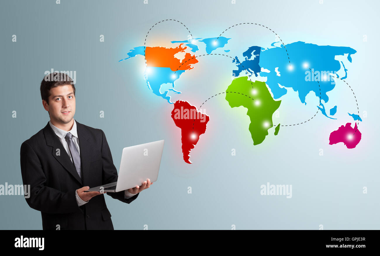 young man holding a laptop and presenting colorful world map Stock ...