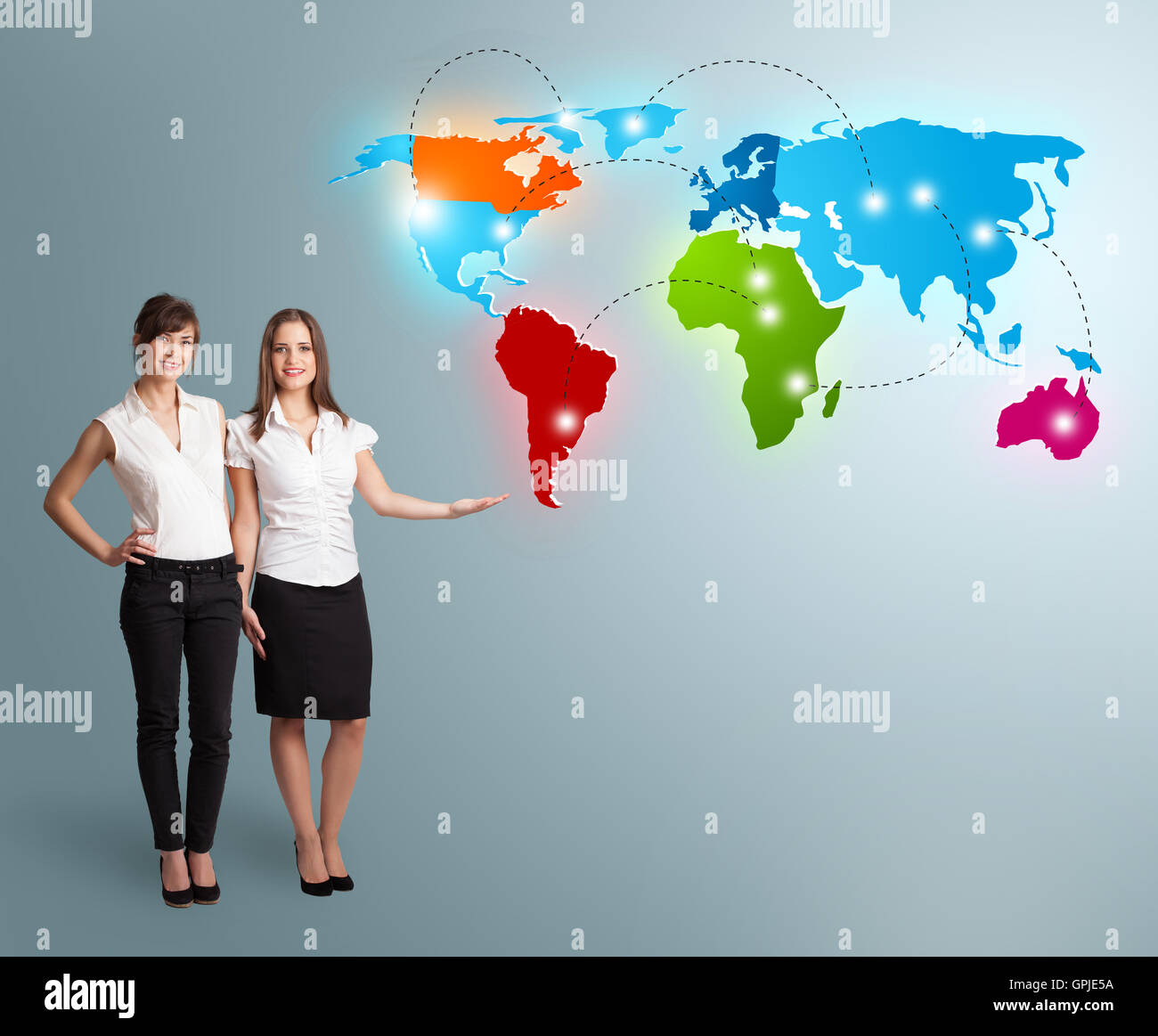 young women presenting colorful world map Stock Photo - Alamy