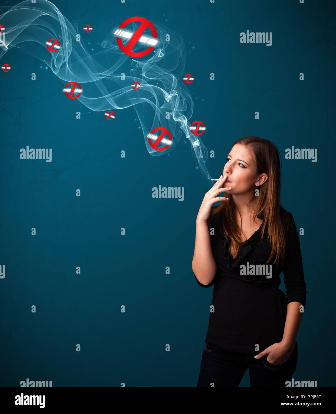 Young woman smoking dangerous cigarette with no smoking signs Stock ...