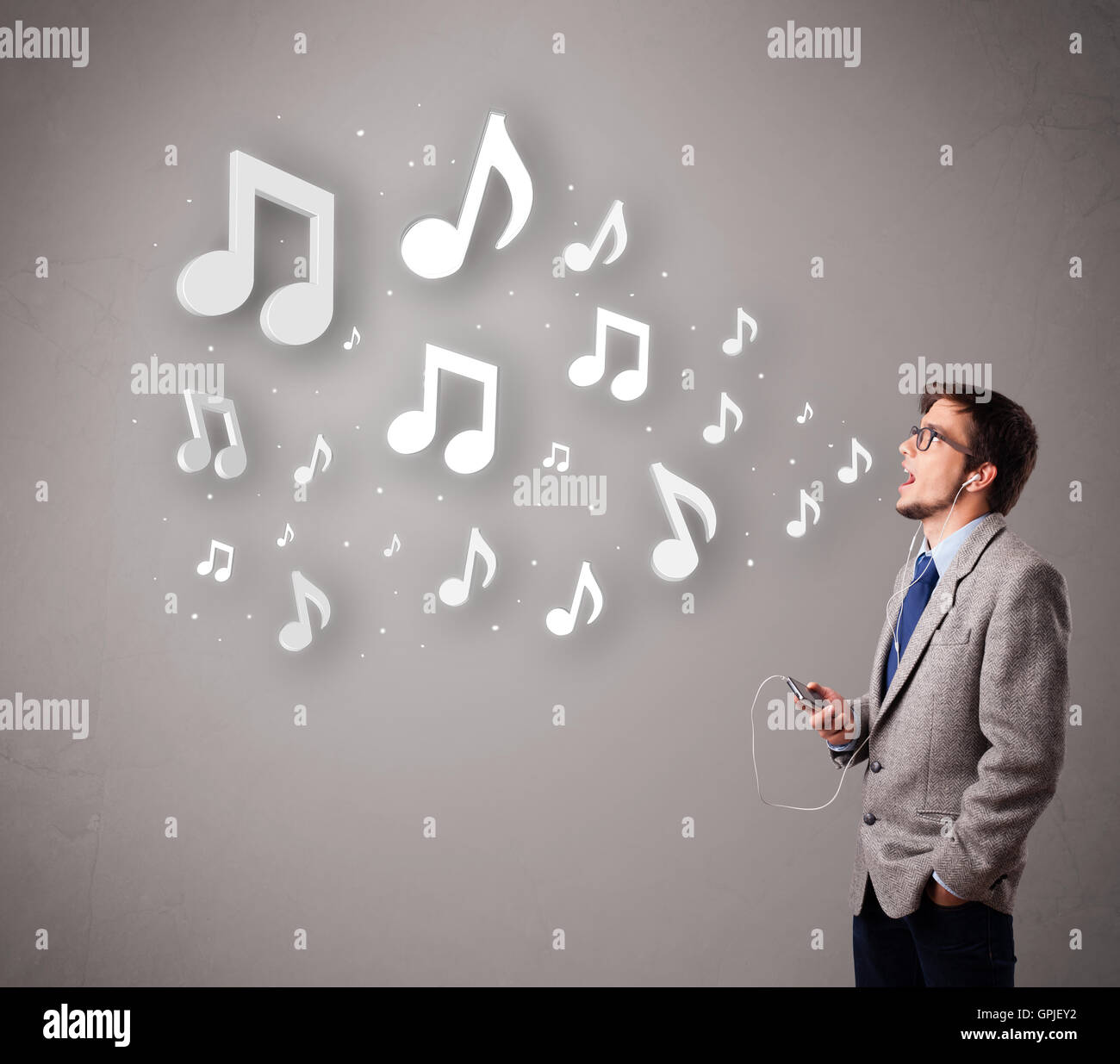attractive young man singing and listening to music with musical Stock ...