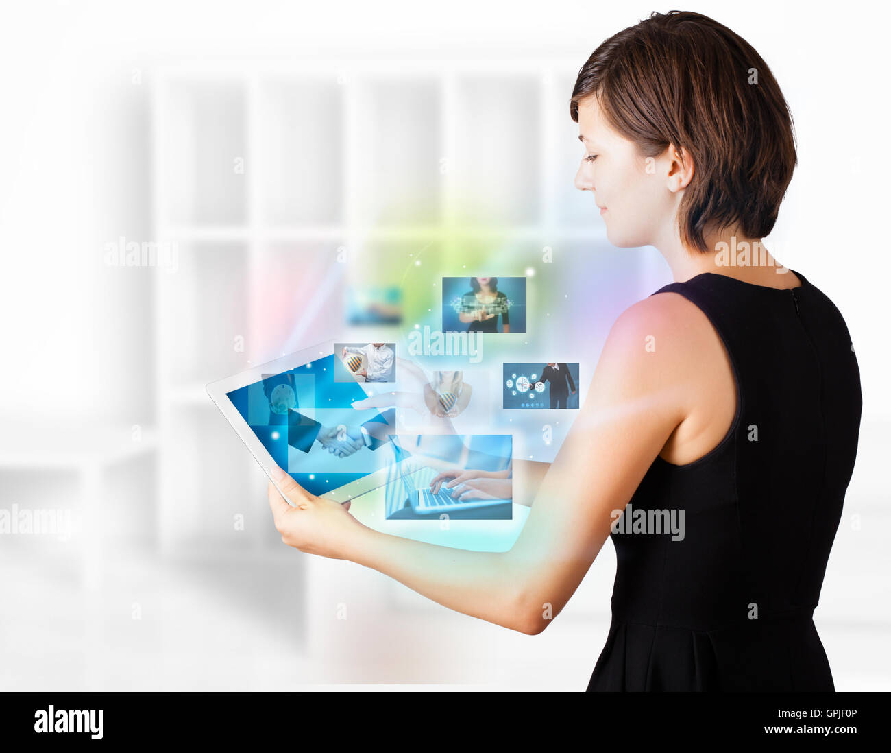 Young woman browsing pictures on modern tablet Stock Photo - Alamy