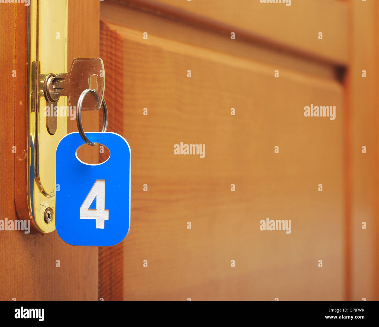 Door wood and key in keyhole with numbered label Stock Photo - Alamy