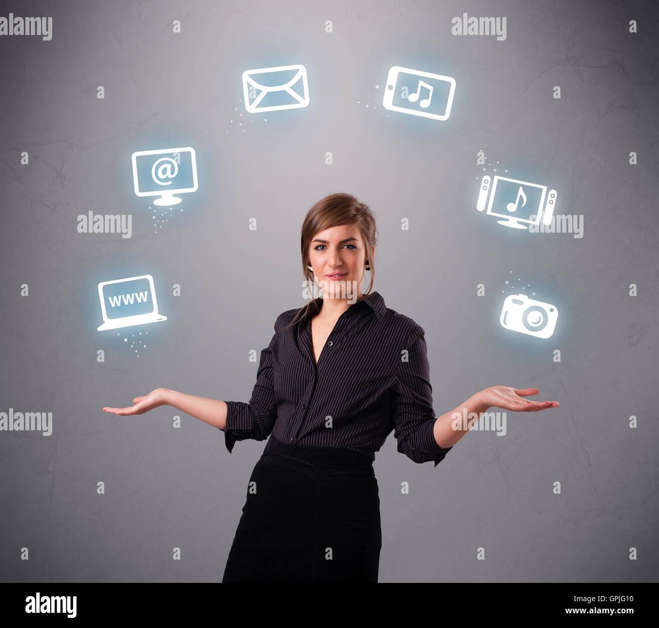 pretty girl juggling with elecrtonic devices icons Stock Photo - Alamy
