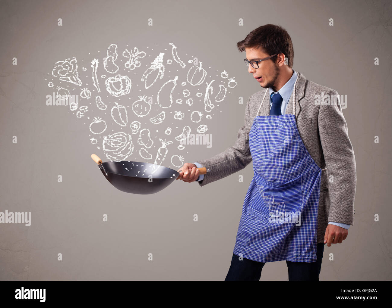Attractive man cooking vegetables Stock Photo - Alamy