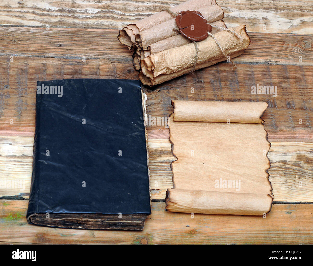 Scrolls of vintage paper with old book Stock Photo - Alamy