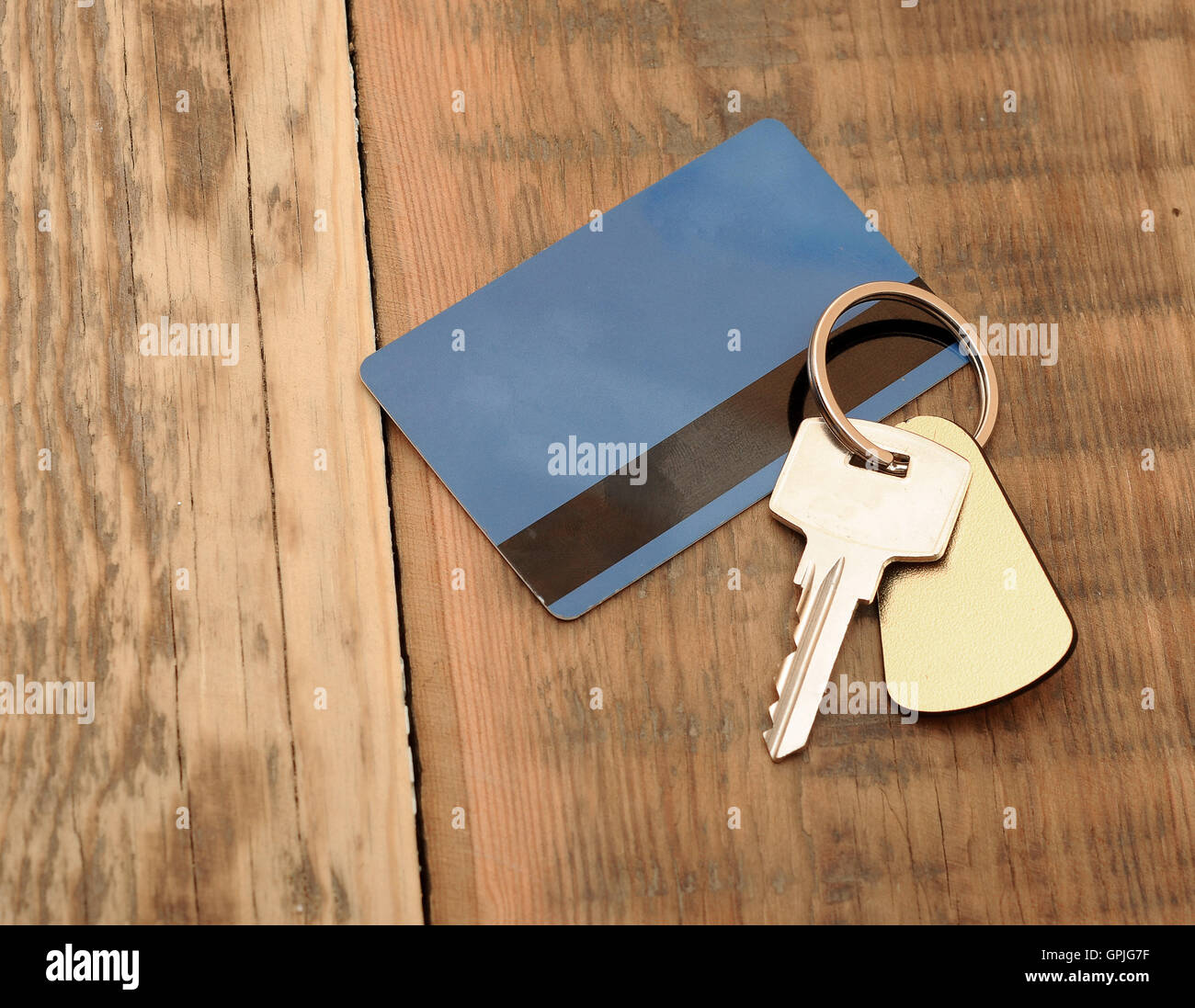 key with plastic card on wooden background Stock Photo - Alamy