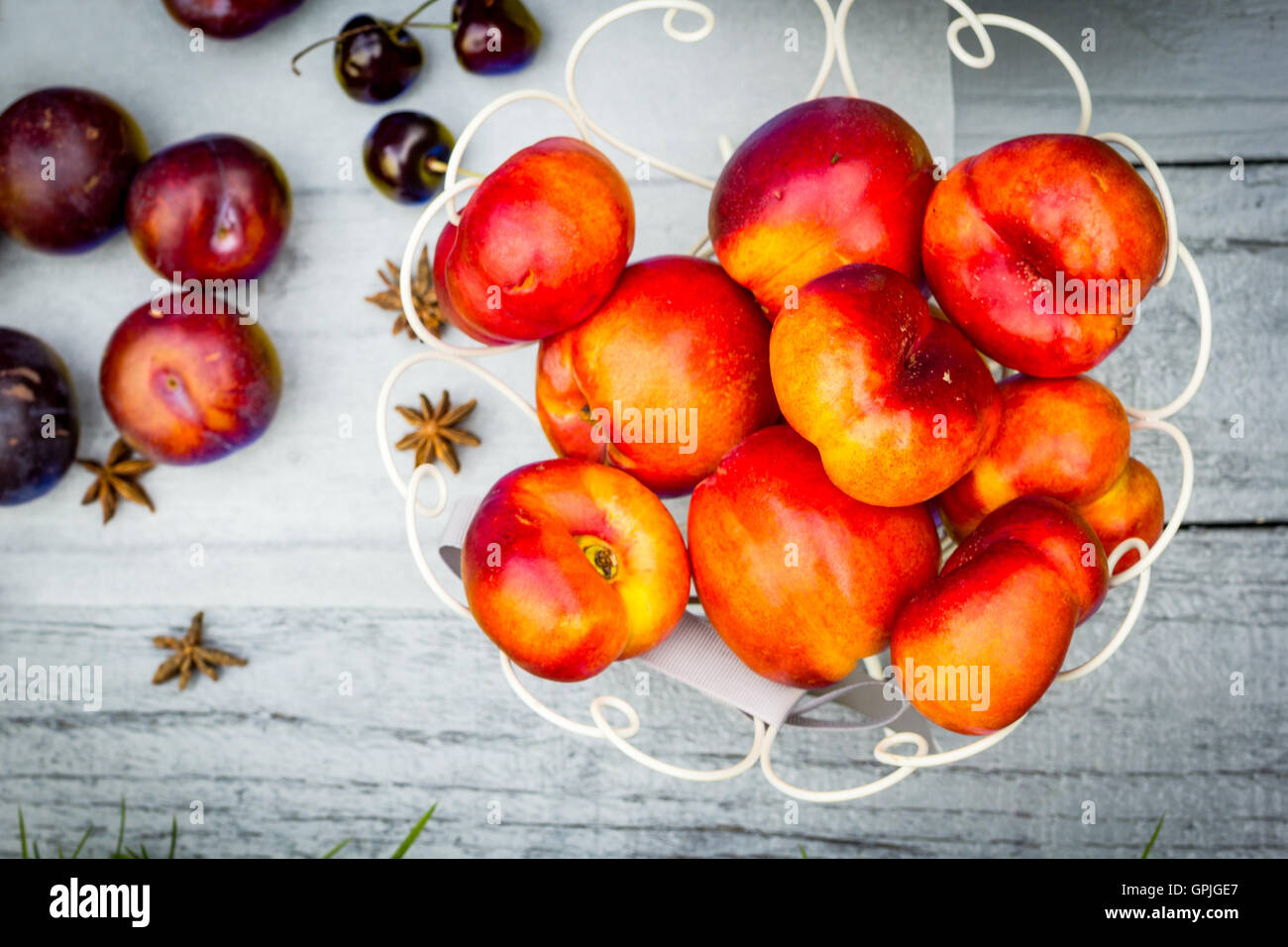 Stone Autumn fruit on the wooden table, flat view Stock Photo - Alamy