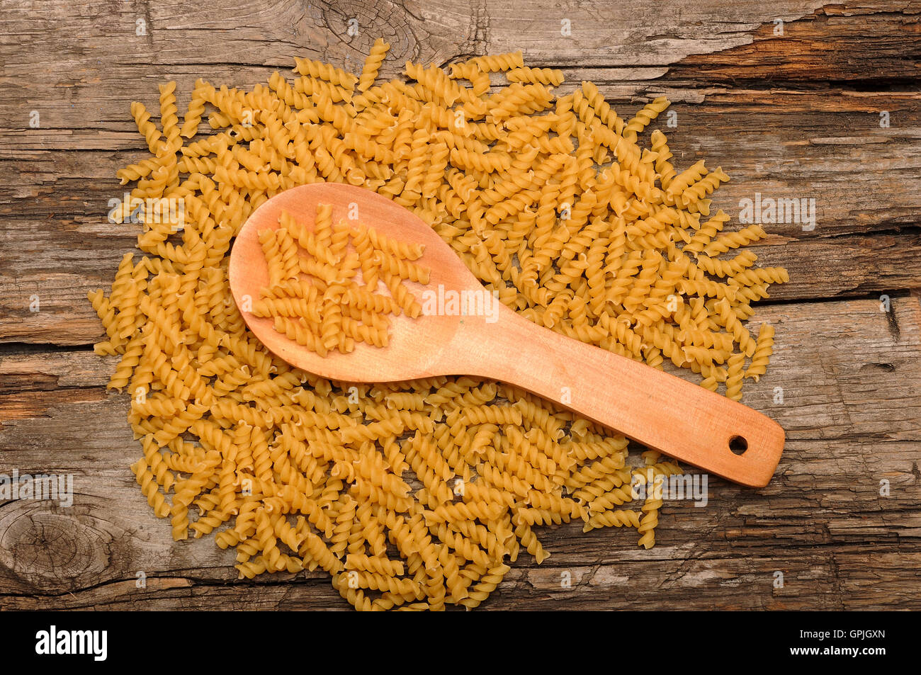 background of pasta and a wooden spoon Stock Photo - Alamy