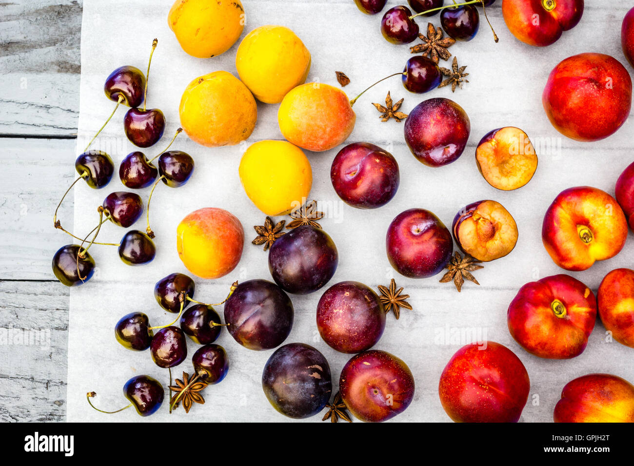 Stone Autumn fruit on the wooden table, flat view Stock Photo - Alamy