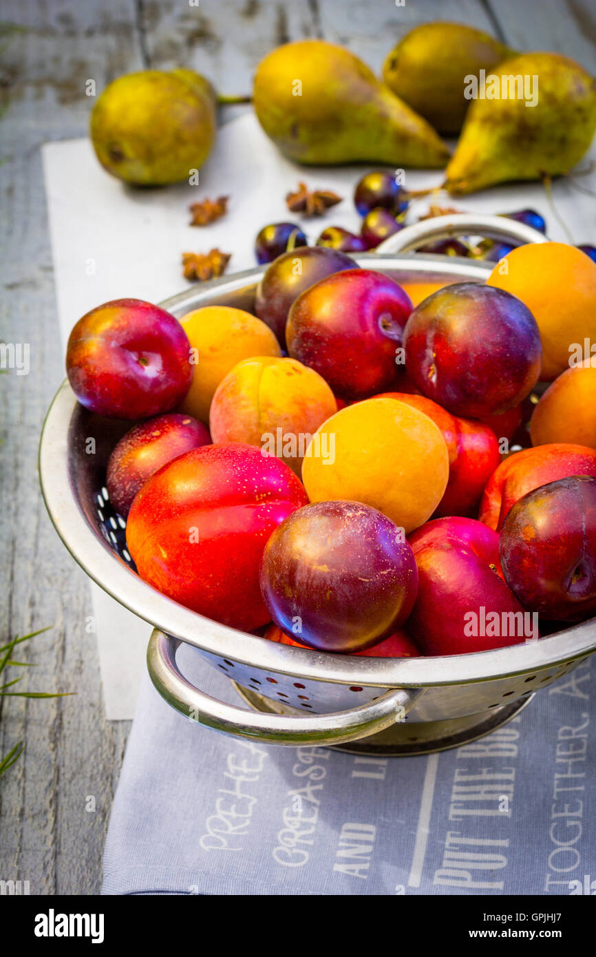 Stone Autumn fruit on the wooden table, flat view Stock Photo - Alamy
