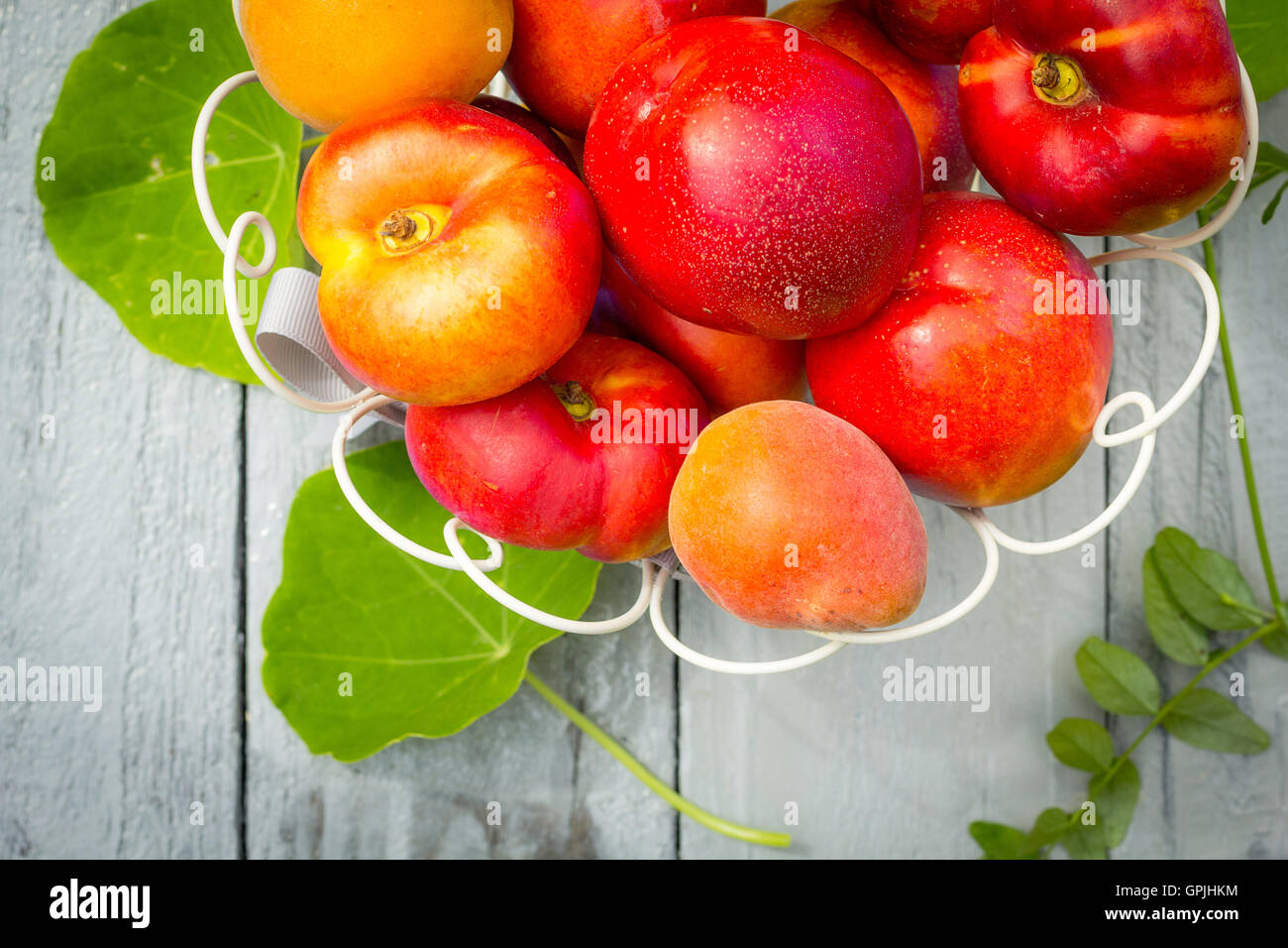 Stone Autumn fruit on the wooden table, flat view Stock Photo - Alamy