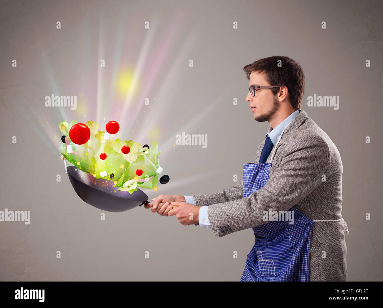 Young man cooking fresh vegetables Stock Photo - Alamy