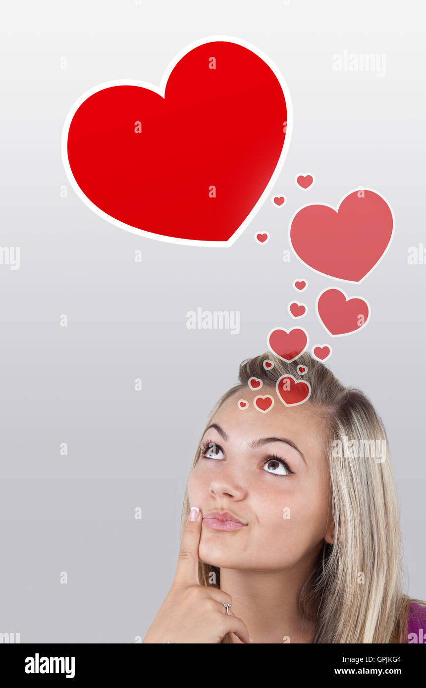 Young girl looking at love type of icons Stock Photo - Alamy