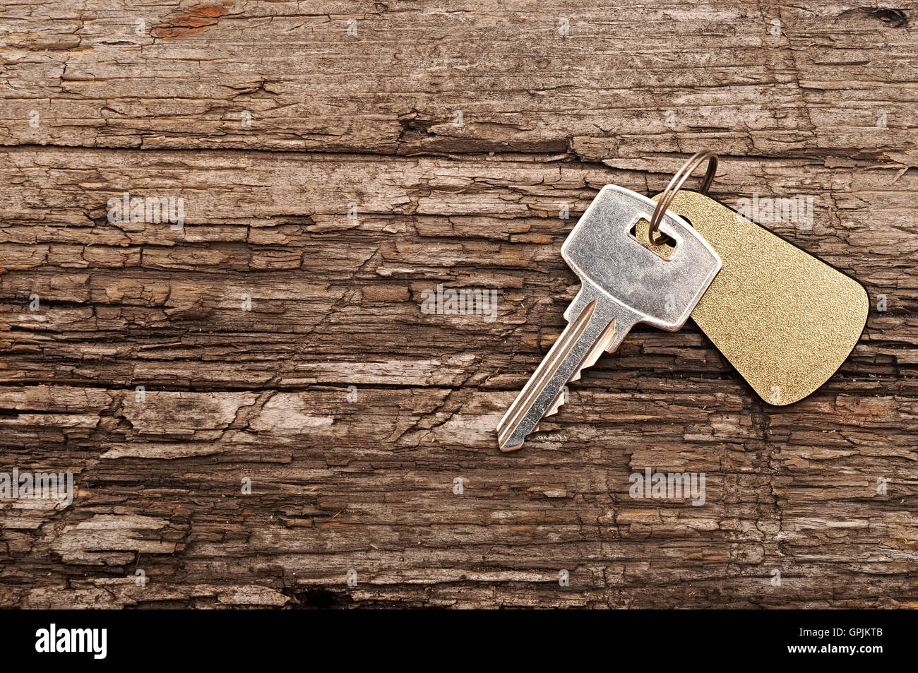 single key on a wooden table Stock Photo - Alamy