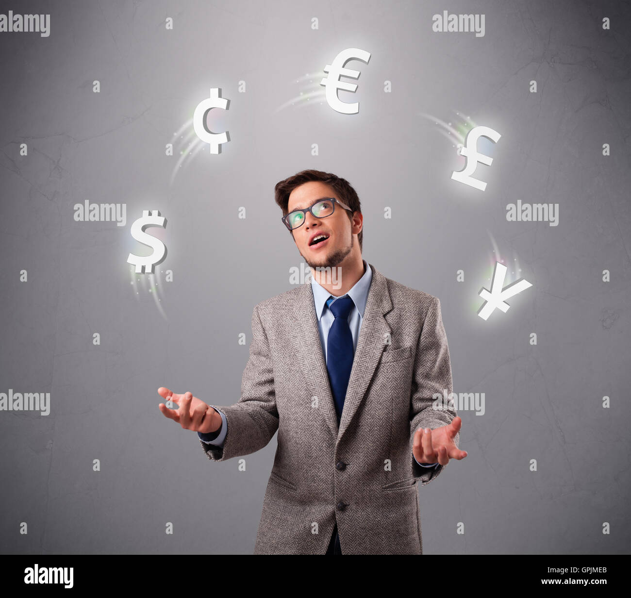 young man standing and juggling with currency icons Stock Photo - Alamy