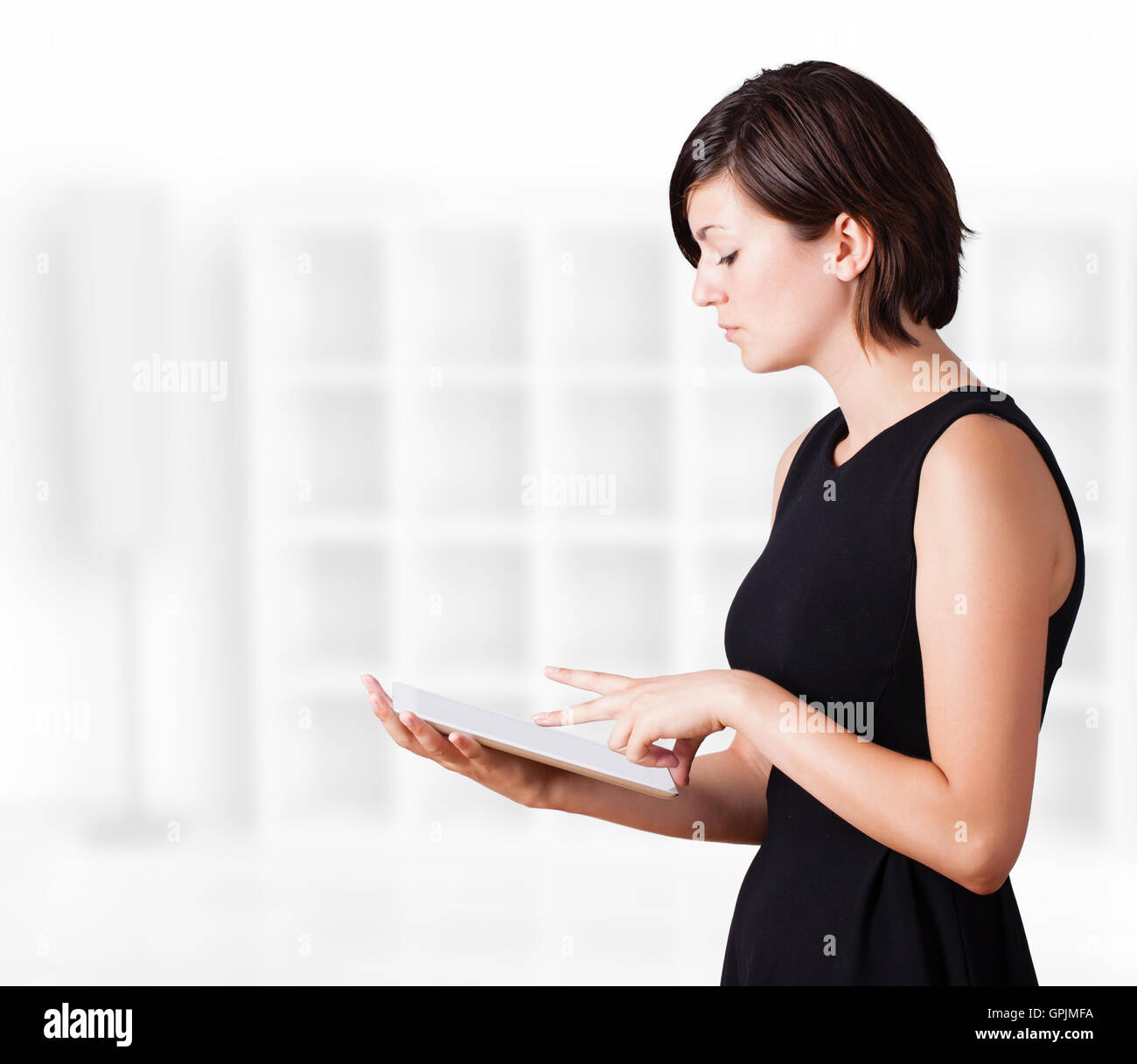 Young woman looking at modern tablet Stock Photo - Alamy
