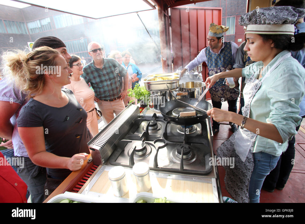 People standing at the Refugees Kitchen and waiting for the food in ...