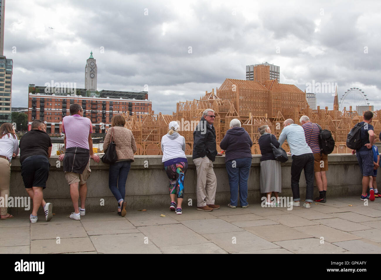 London UK. 4th September 2016. Crowds view the replica wooden sculpture ...