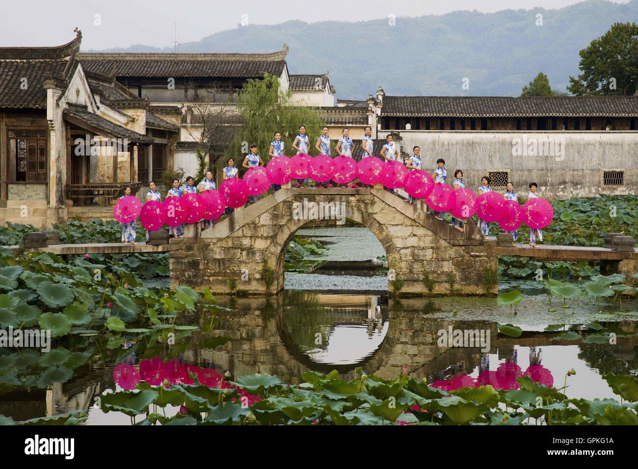 .Twenty women wearing traditional Chinese dress Cheongsam perform a ...