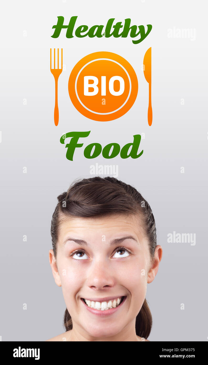 Young girl looking at healthy food sign Stock Photo - Alamy