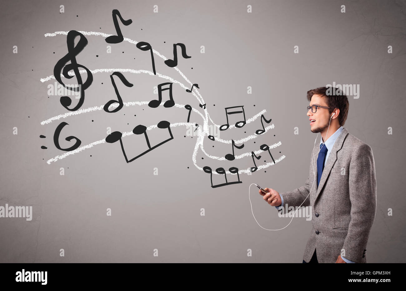 handsome boy singing and listening to music with musical notes Stock ...