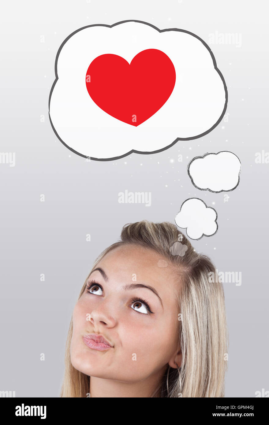 Young girl looking at love type of icons Stock Photo - Alamy